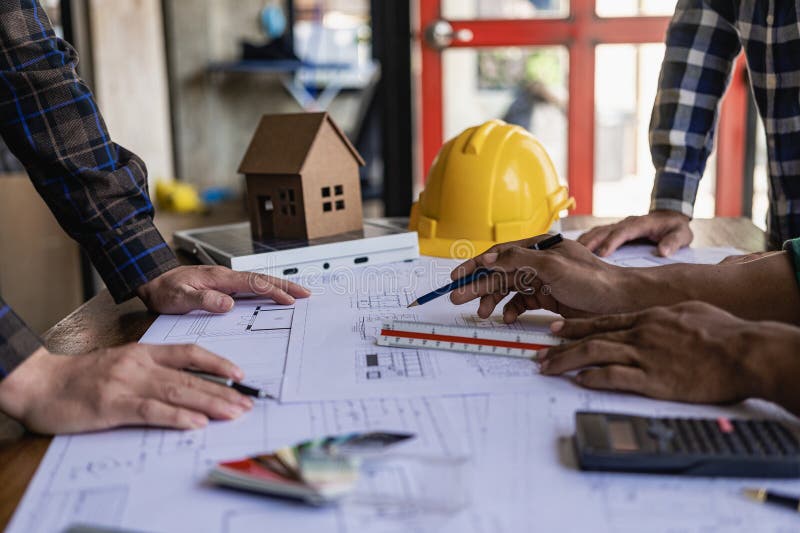 Engineer Pointing at Blueprint and Using Laptop To Draw Project Design ...