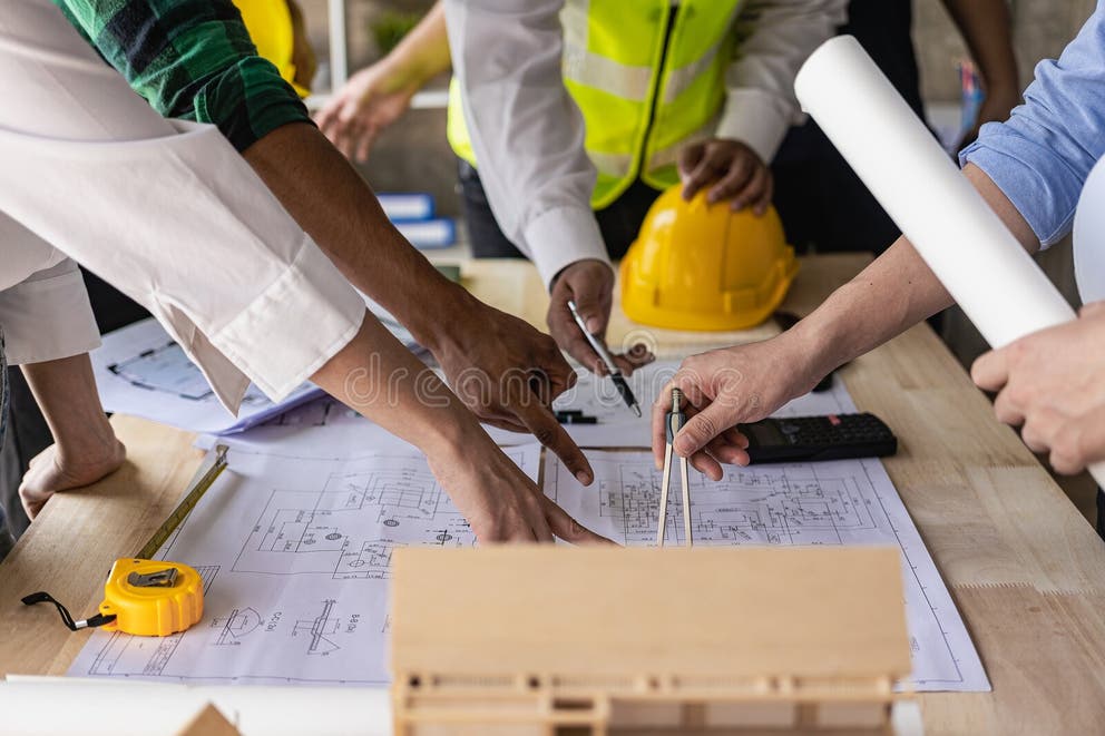 Engineer Pointing at Blueprint and Using Laptop To Draw Project Design Building Construction ...