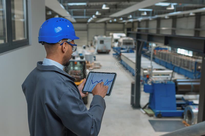 Engineer Programmer Using Tablet and Graphics Data To Check Factory ...