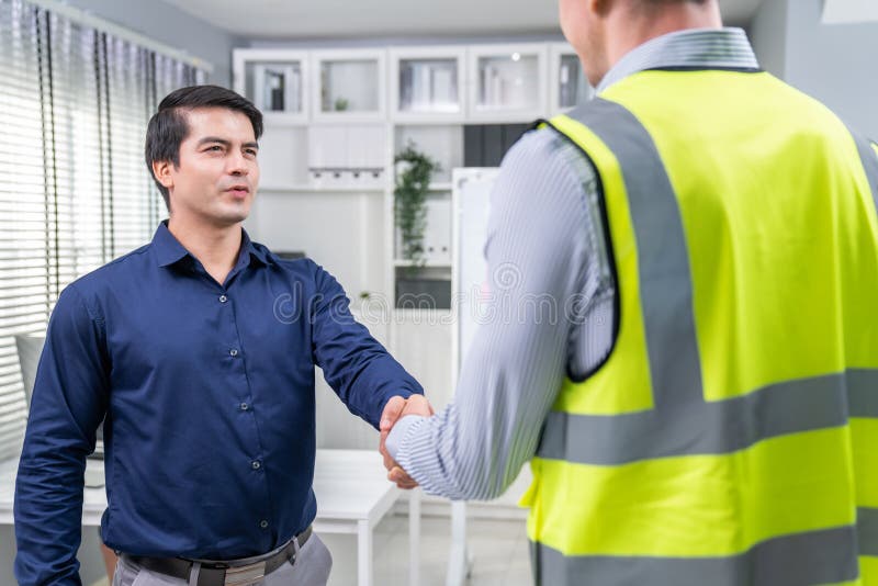 An Engineer with a Protective Vest Handshake with an Investor in His ...