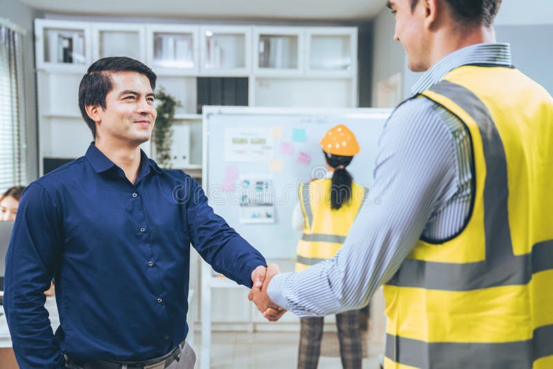 An Engineer with a Protective Vest Handshake with an Investor in His ...