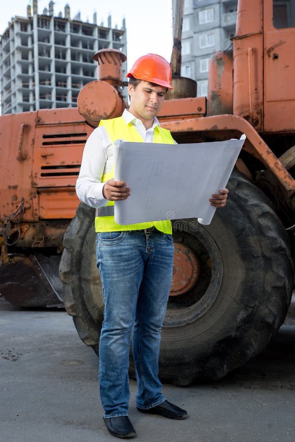 Engineer Reading Instruction To Bulldozer Building Site Stock Photos ...