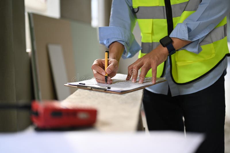 Engineer in Reflective Vest Standing in Construction Site and Checking ...