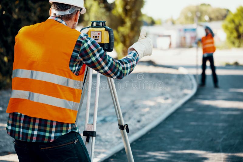 Engineer in Reflective Vest Using Equipment during Geodetic Work Stock ...