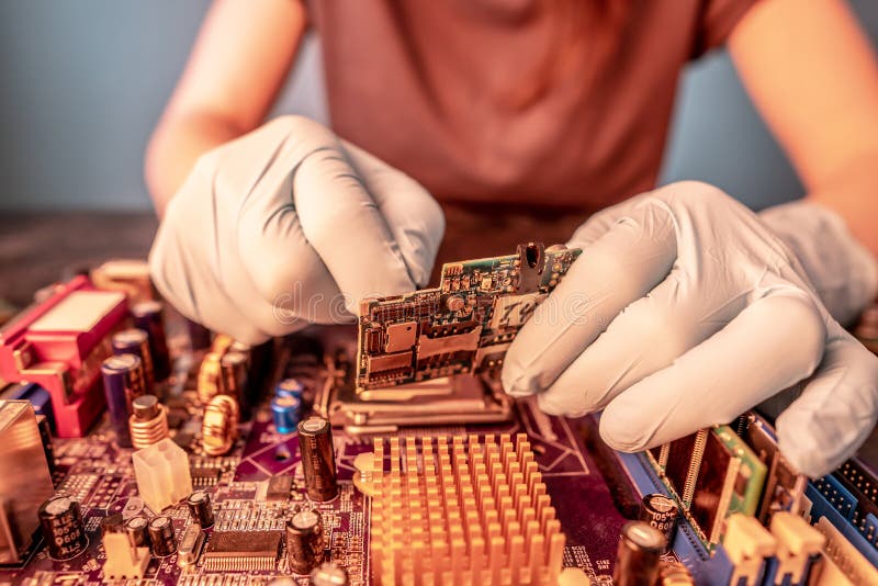 The Engineer`s Gloved Hand Holds the Computer`s RAM Chip Against the ...