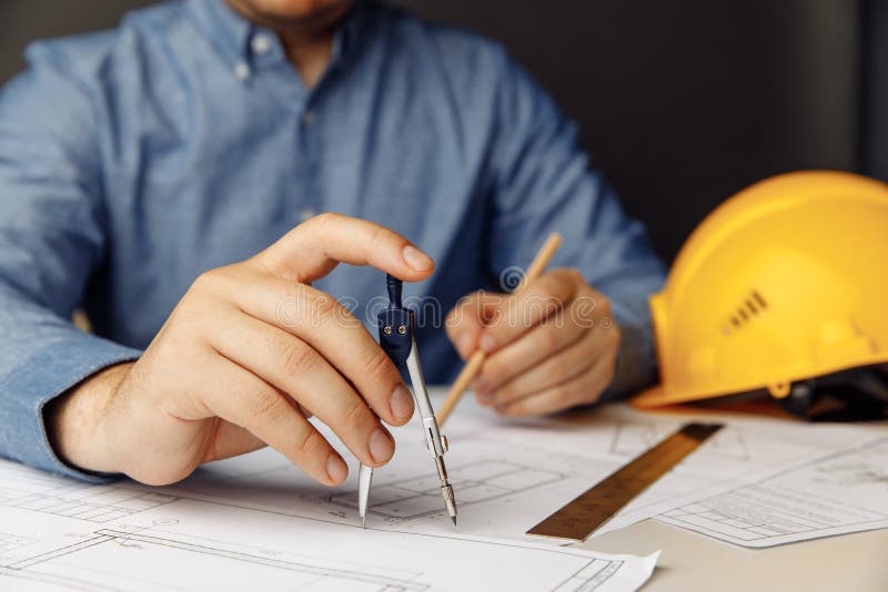 Engineer& X27;s Workplace with Yellow Helmet and Drawing Tools. Man ...