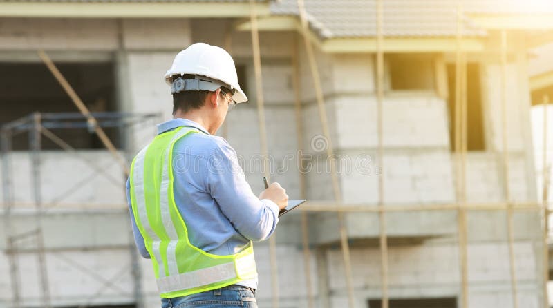Engineer with Digital Tablet Works on a Field of Wind Turbines Stock ...