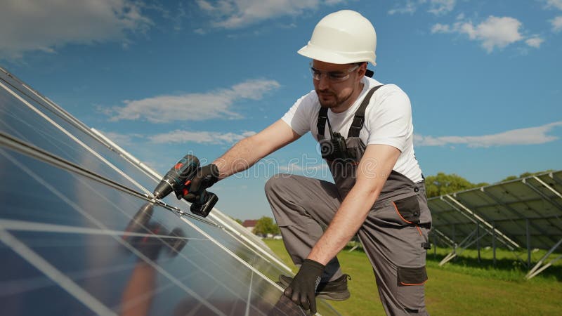 Engineer Installing Solar Panels with a Power Drill Outdoors Stock ...