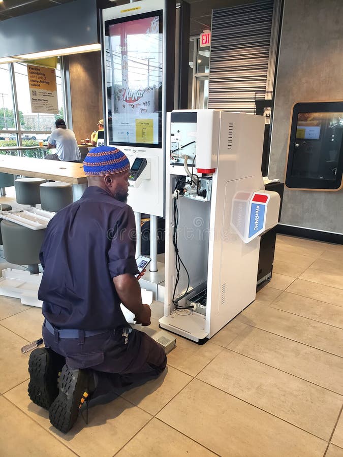 Engineer Setting Up a New Vending Machine To Serve Customers at a ...