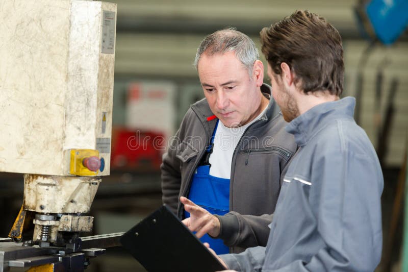 Engineer Showing Apprentice How To Use Cnc Tool Making Machine Stock ...