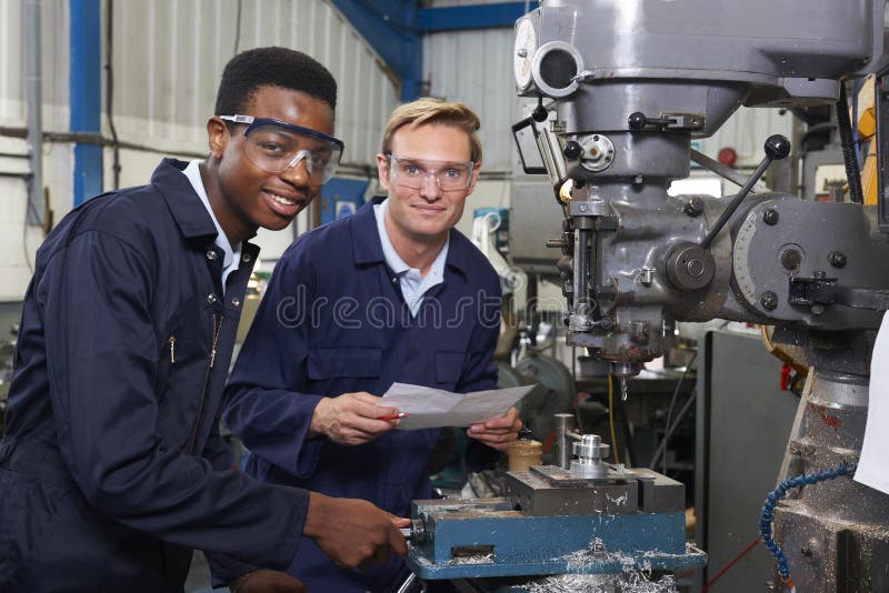 Engineer and Apprentice Working on Machine in Factory Stock Image ...