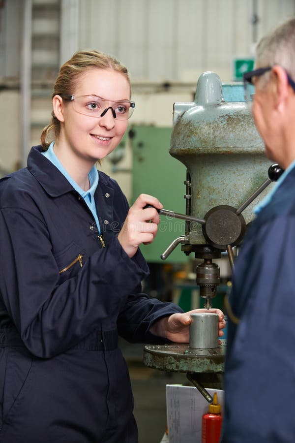 Engineer Showing Female Apprentice How To Use Drill Stock Image - Image ...