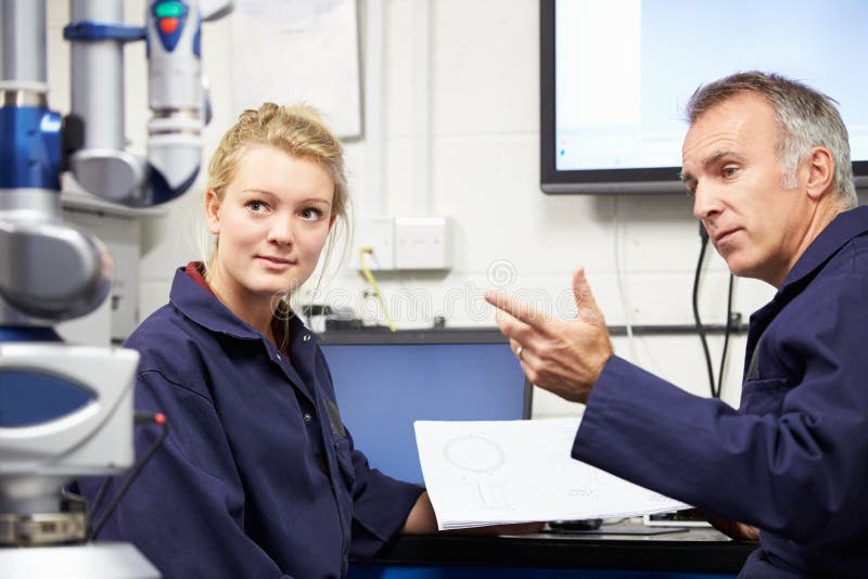 Trainee Engineer Studying Plans with CMM Arm in Foreground Stock Image ...