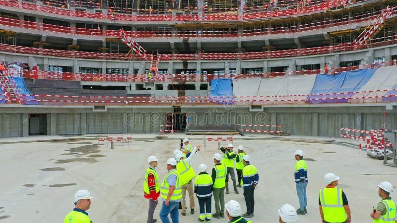 Engineer Shows Stadium To Journalists at Construction Site Stock ...