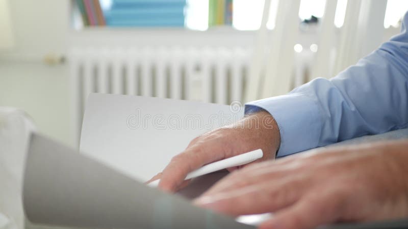 Engineer Sit on a Chair in Office Room Open a Plan and Draw Using a Pen ...