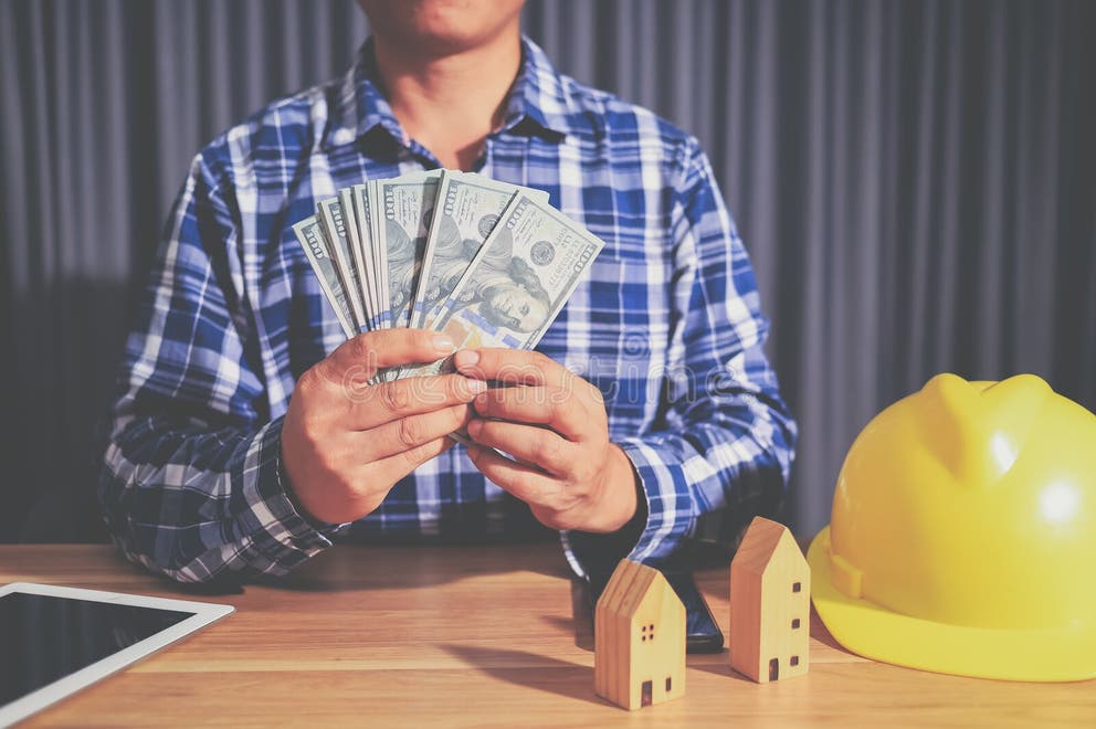 Engineer Sitting and Counting Dollar Bills. Stock Image - Image of data ...