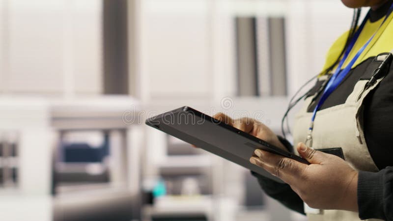 Engineer in Smart Factory Oversees Robotic Assembly Lines Using Tablet ...