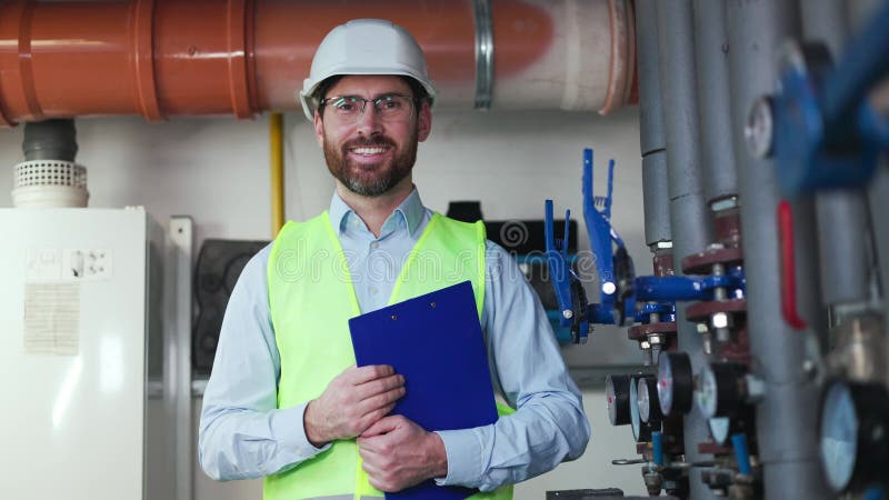 Engineer Smiling at Camera, Holding Tablet in a Manufacturing Factory ...