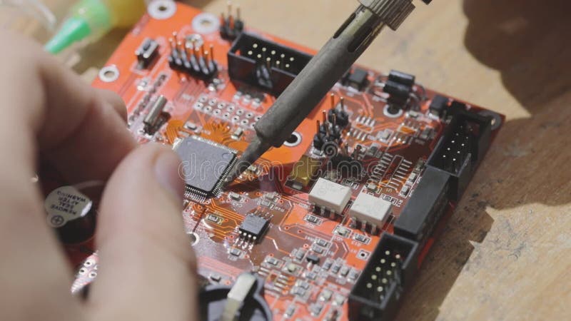 Engineer Solder Chip To Microchip. Close-up of Soldering Microcircuit ...