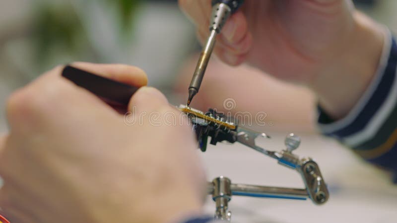 Engineer Soldering a Circuit Board in a High Tech Research Laboratory ...