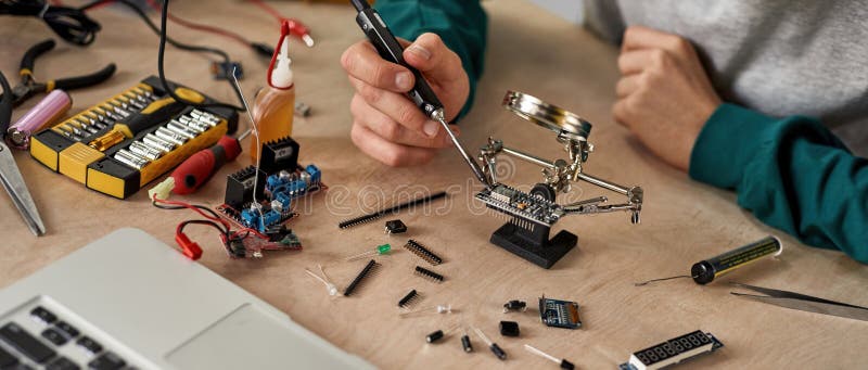 Engineer Soldering Microchip at Table with Laptop Stock Photo - Image ...