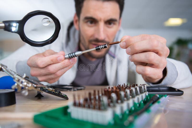 Engineer Soldering Microcircuit Though Magnifier Stock Photo - Image of ...