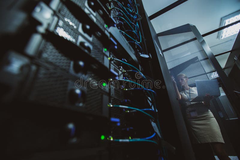 It Engineer Standing Amid Working Server Racks Doing Routine ...