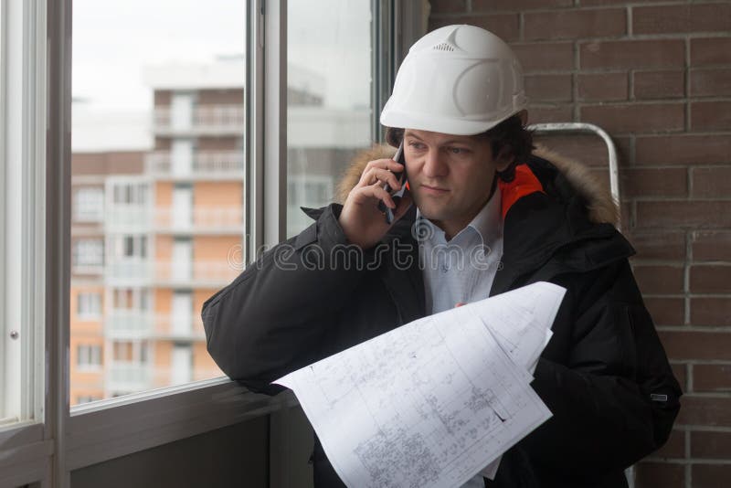 Engineer Standing on the Background of a New Apartment Building. House ...