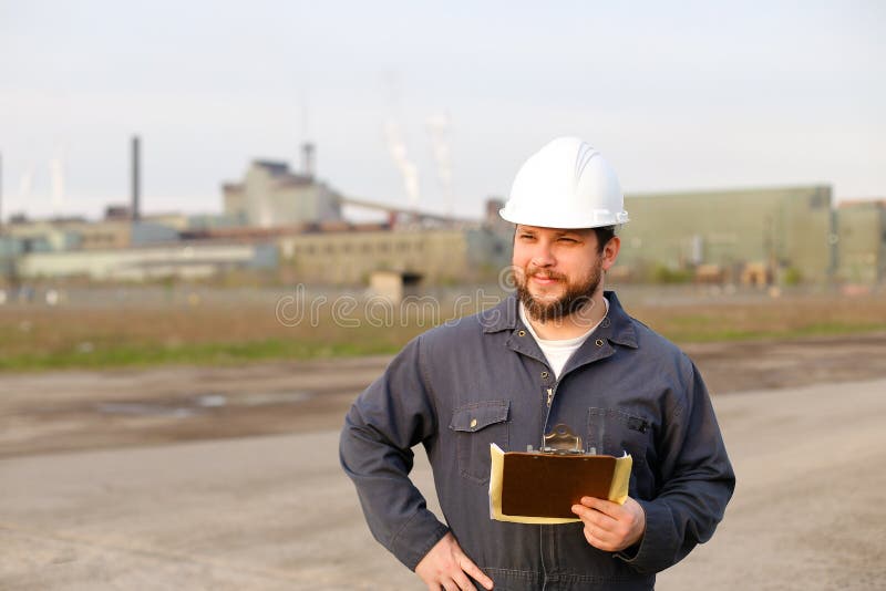 Engineer Standing on Construction Site and Holding Papers. Stock Photo ...