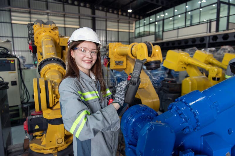 Engineer Standing by Robotic Arm and Operating Machine in Industry ...