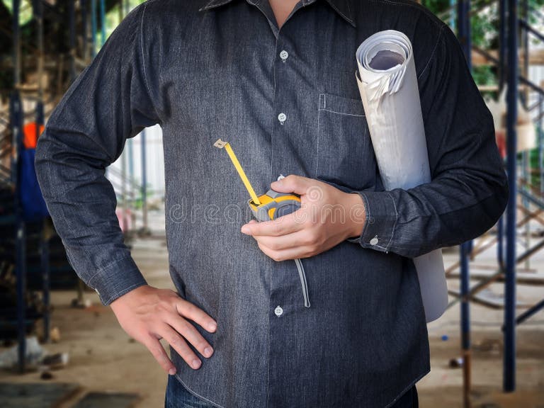 Engineer in Suit with Blueprint and Helmet in Construction Site Stock ...