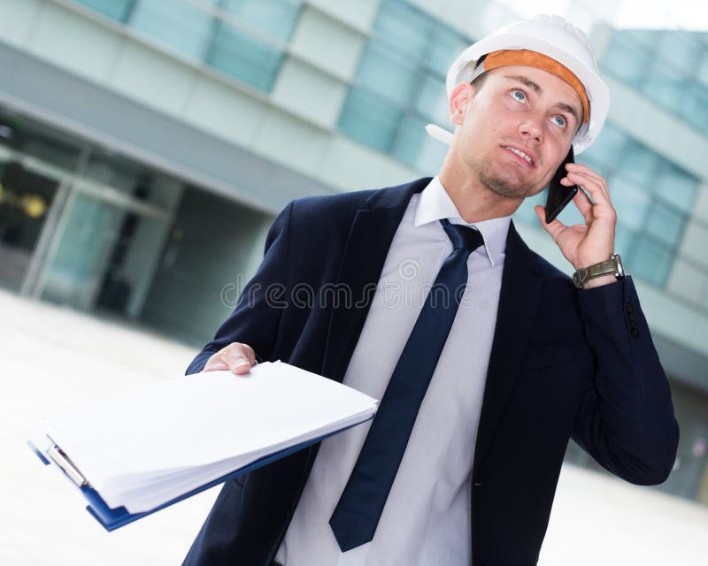 Engineer in Suit and Hat is Taking Document Case and Considering ...
