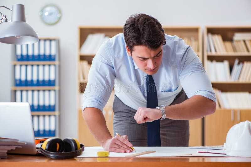 The Engineer Supervisor Working on Drawings in the Office Stock Photo ...