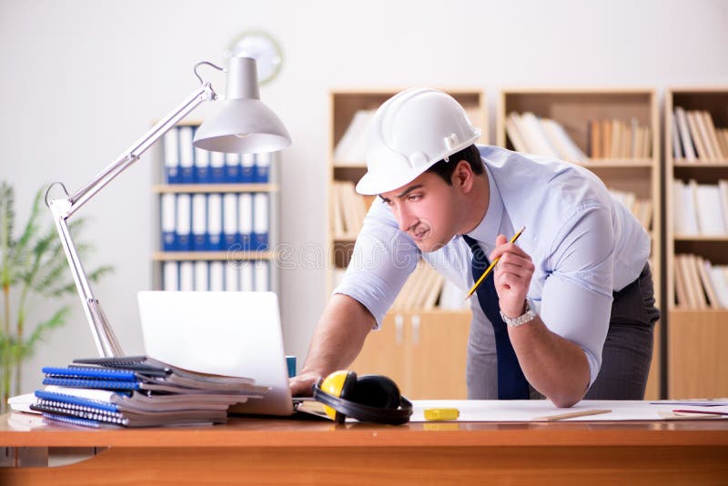 The Engineer Supervisor Working on Drawings in the Office Stock Photo ...