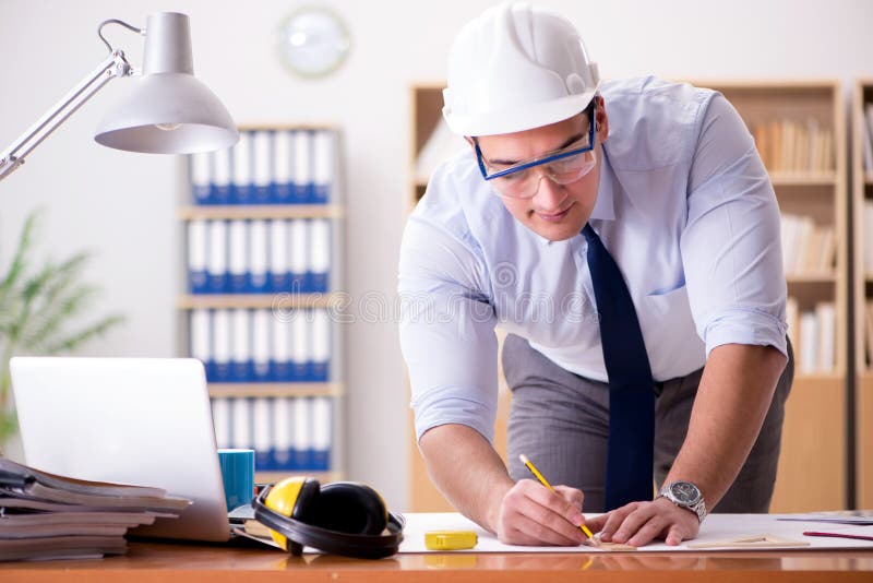 The Engineer Supervisor Working on Drawings in the Office Stock Photo ...