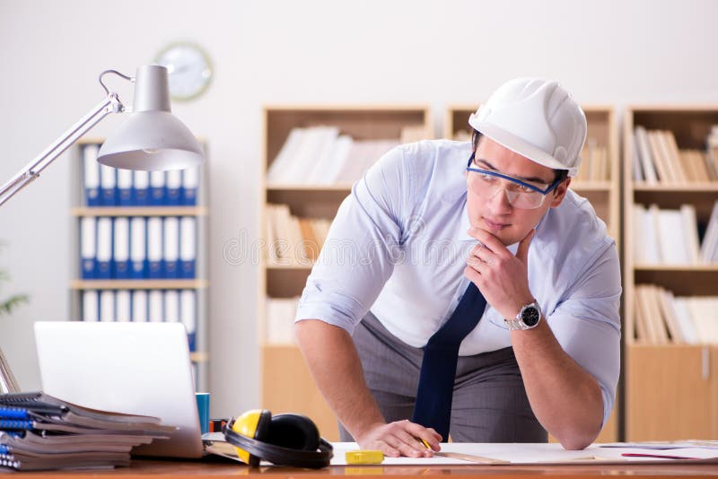 The Engineer Supervisor Working on Drawings in the Office Stock Photo ...