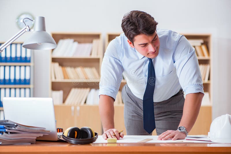 The Engineer Supervisor Working on Drawings in the Office Stock Photo ...