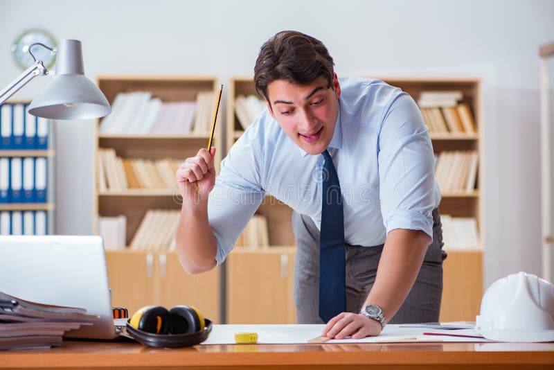 The Engineer Supervisor Working on Drawings in the Office Stock Photo ...