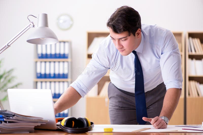 The Engineer Supervisor Working on Drawings in the Office Stock Photo ...
