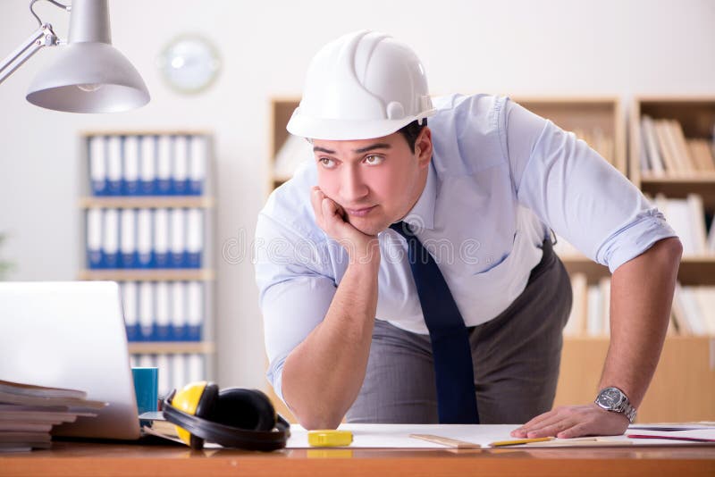 The Engineer Supervisor Working on Drawings in the Office Stock Photo ...