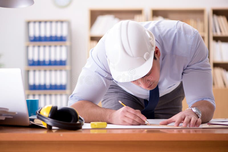 The Engineer Supervisor Working on Drawings in the Office Stock Photo ...
