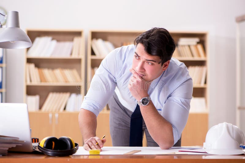 The Engineer Supervisor Working on Drawings in the Office Stock Photo ...