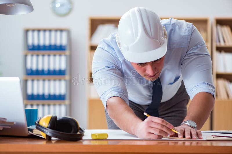 The Engineer Supervisor Working on Drawings in the Office Stock Photo ...