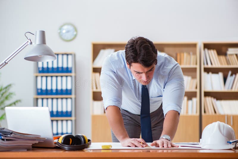 The Engineer Supervisor Working on Drawings in the Office Stock Photo ...