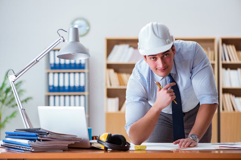 The Engineer Supervisor Working on Drawings in the Office Stock Photo ...
