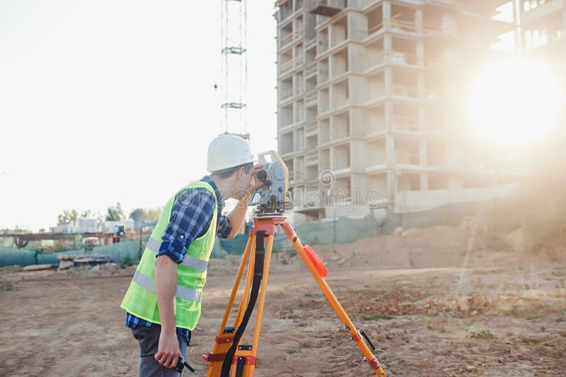 Surveyor Engineer in Protective Wear Using Geodetic Equipment Stock ...