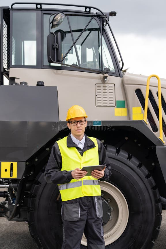 Engineer with Tablet Computer Stands Next To Mining Truck Stock Image ...