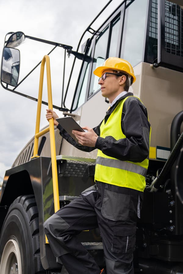 Engineer with Tablet Computer Stands on the Stairs To the Cab of a ...