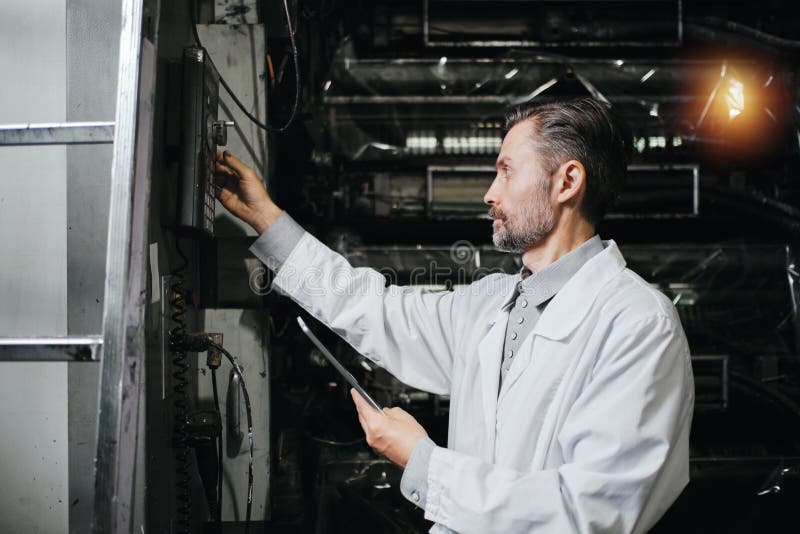 Engineer Working at the Factory with Machinery and Gadgets Stock Image ...