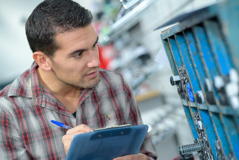 Engineer Taking Notes at Control Room in Factory Stock Photo - Image of ...